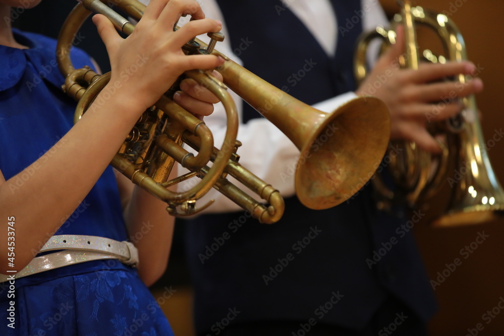 Children playing the trumpet little girl and boy players holding a ...