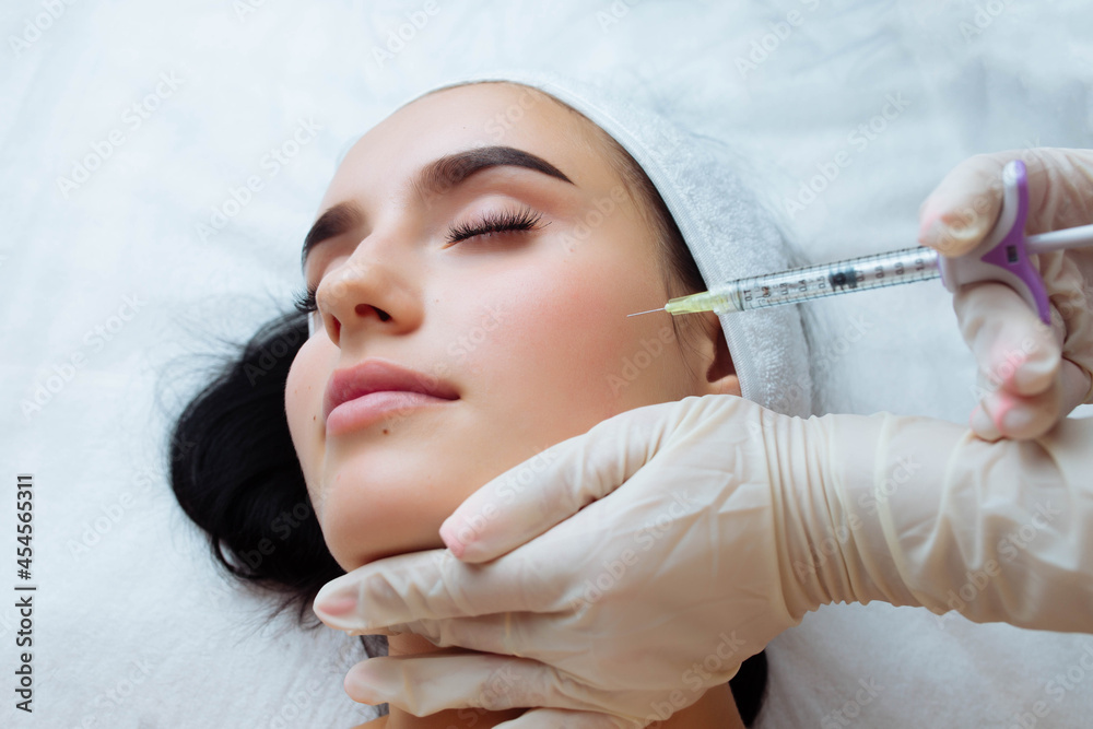 Smile lifting and lip augmentation. Beautician doctor hands doing ...