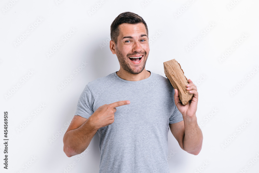 Happy man standing over white studio background and pointing at ...