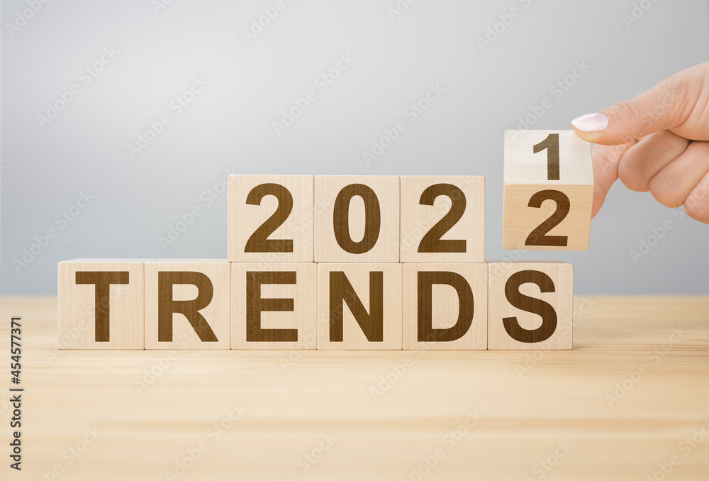 2022 trends new year symbol. Businesswoman turns a wooden cube and ...