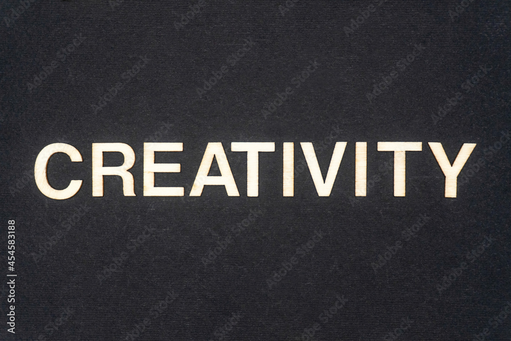 CREATIVITY word written on dark paper background. CREATIVITY text for ...