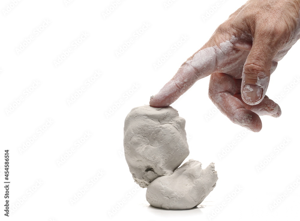 Grey modelling clay shaped in dirty clay hands isolated on white ...