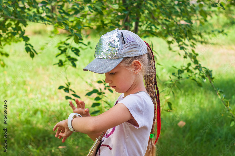 Child schooler using smartwatch outdoor park. Kid talking on vdeo call ...
