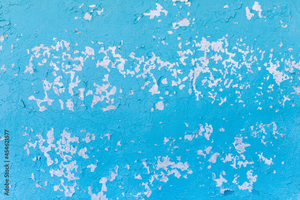 Blue flakes of old peeled dirty paint from the surface of the white ...