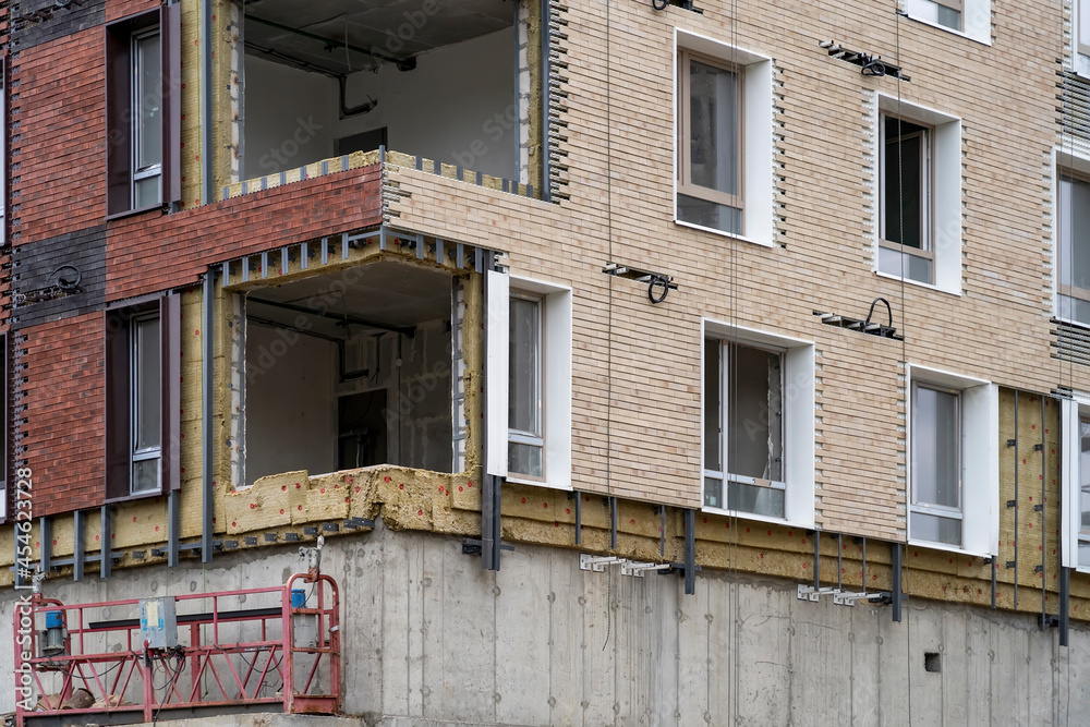 Facing building with ventilated facade. Modern facades of high-rise ...