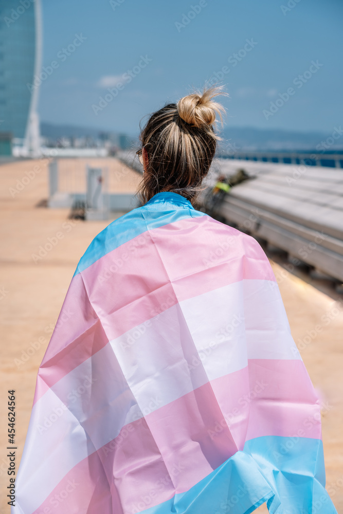 transsexual woman with trans flag, holding a transgender pride flag ...