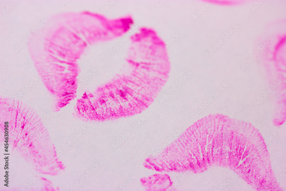 Beautiful shape pink female lip prints on white paper background top ...