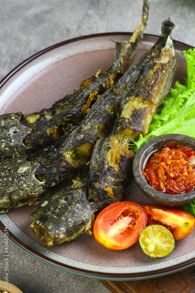 Lele Goreng or Pecel Lele with sambal served with fresh lettuce and ...