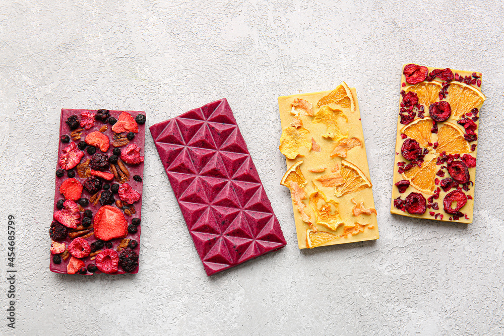 Handmade chocolate bars with fruits, berries and nuts on light ...