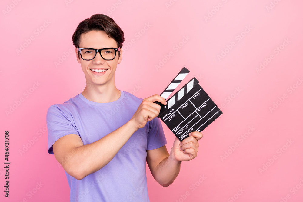 Portrait of attractive cheerful guy filmmaker using chalkboard isolated ...