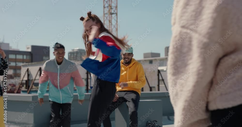 funny woman dancing with friends on rooftop at dance party enjoying ...