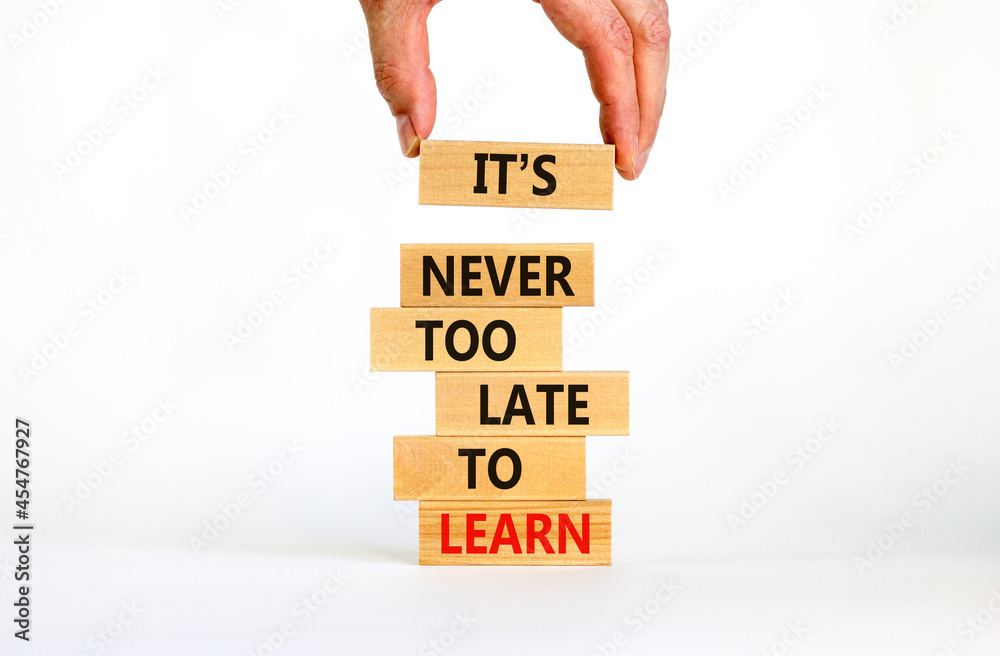 Learn symbol. Wooden blocks with words 'It is never too late to learn ...