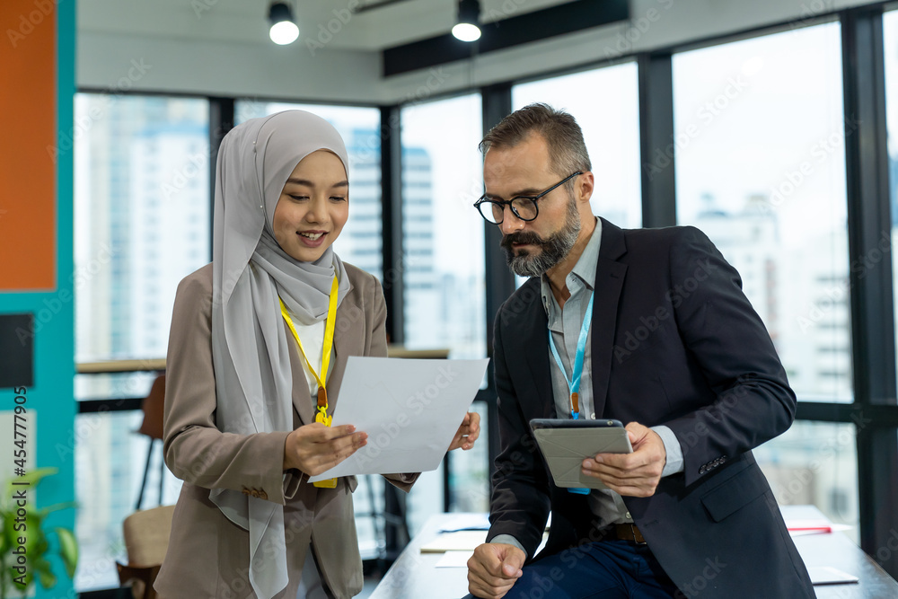 Asian Muslim business woman in hijab headscarf presenting of her work ...