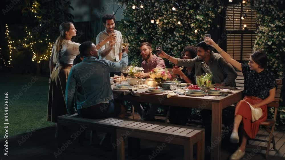 dinner party friends celebrating making toast to friendship at evening ...