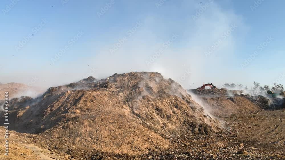 Burning pile of garbage at dump ground or landfill releasing toxic ...