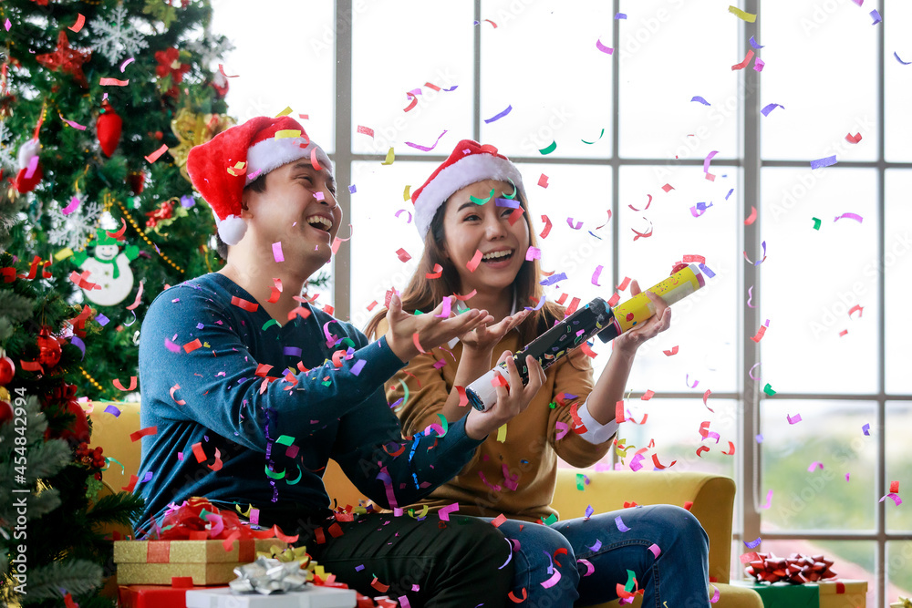 Happy Asian family husband and wife wears sweater with red and white ...