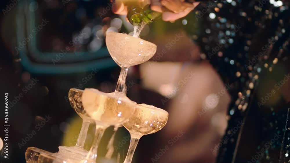 happy celebration woman pouring champagne tower at glamorous dance ...