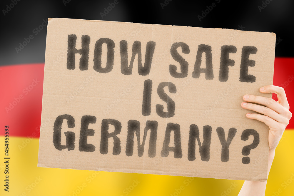 Foto de The question " How safe is Germany? " on a banner in men's hand ...
