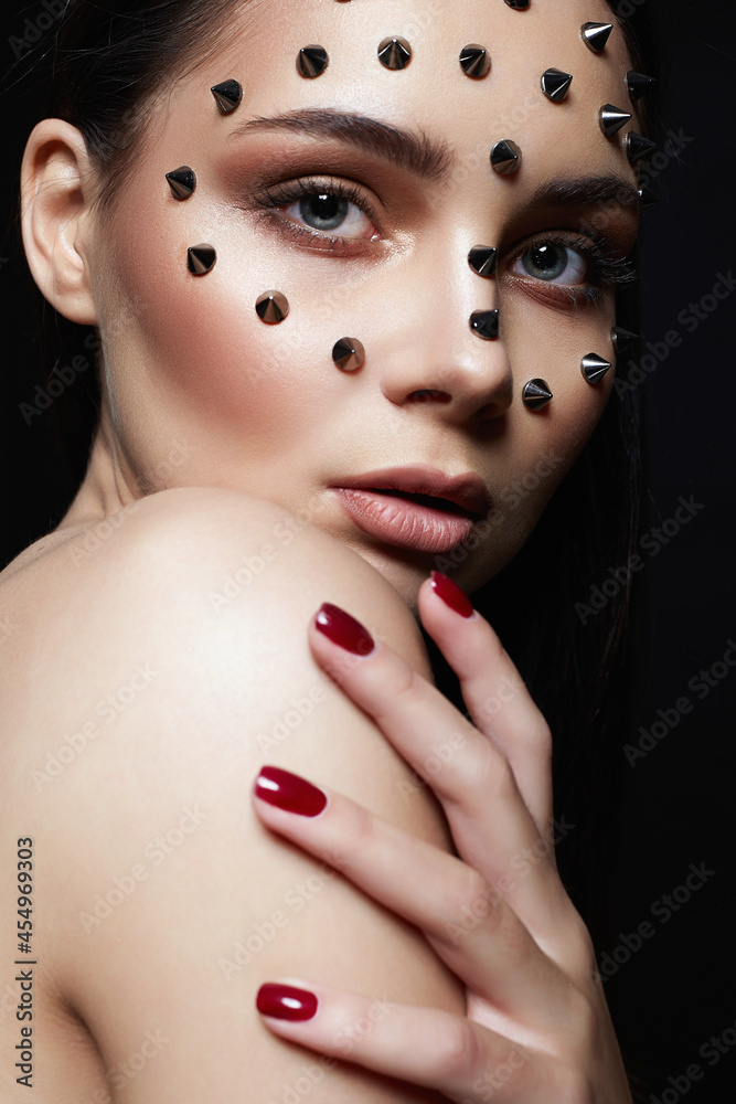 beautiful girl with steel spikes on her Face. Beautiful woman with Make ...