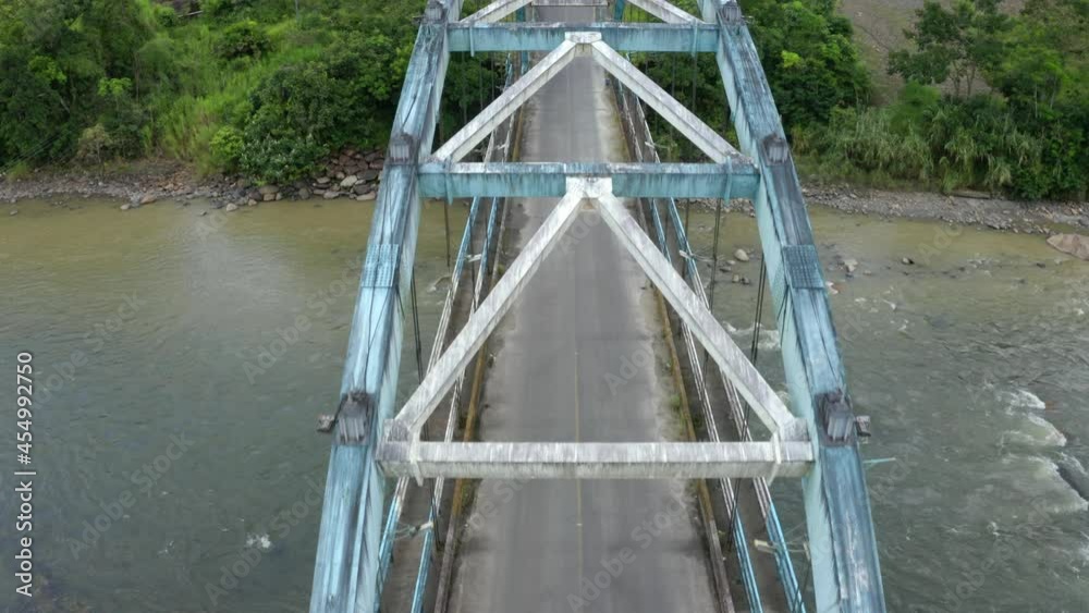Aerial top view of a metal truss bridge, moving over the thick metal ...
