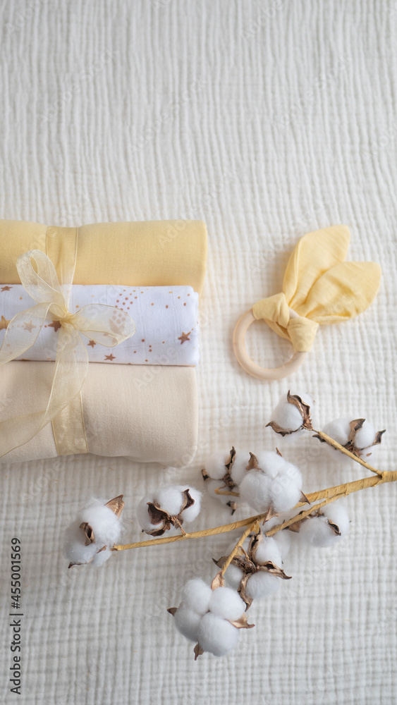 Baby set of yellow cloth diaper with wooden toy and pampas grass ...
