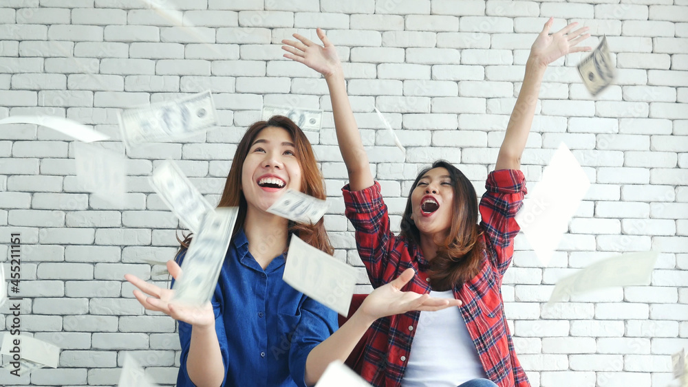 Happy young asian woman holding dollar money and throw in the air ...