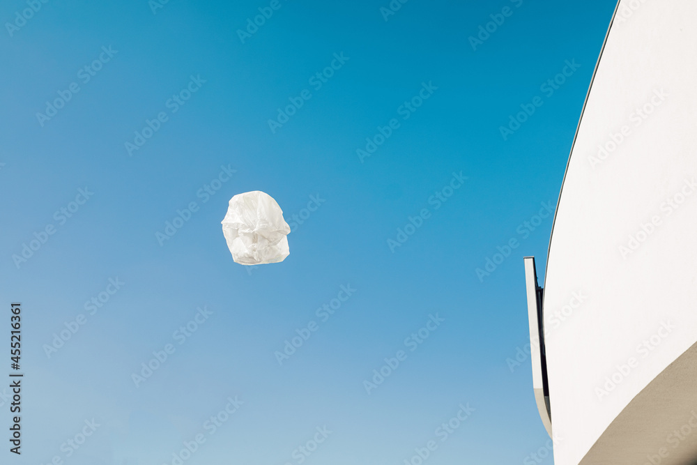 flying empty white plastic bag in front of modern architecture Stock ...
