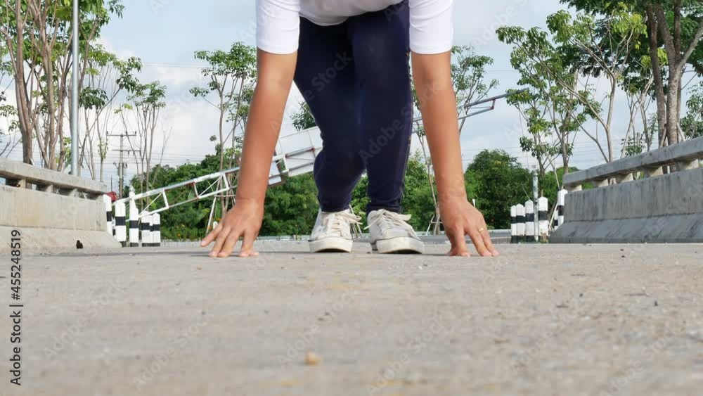 Young woman preparing poses before start running on street way in ...