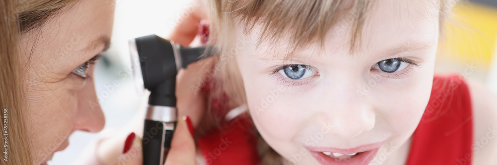 Female doctor conducts examination of ear of little girl Stock Photo ...