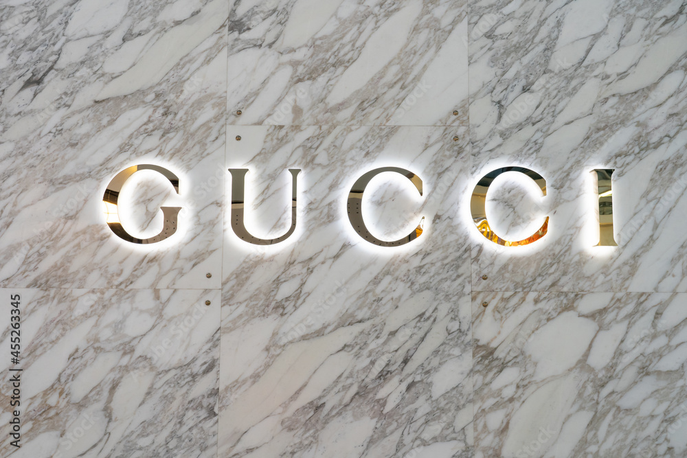 View of GUCCI Logo on white marble background Stock Photo | Adobe Stock