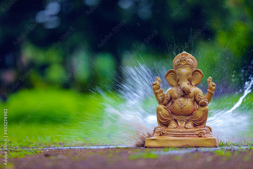 Water splash on lord ganesha sculpture. celebrate lord ganesha festival ...