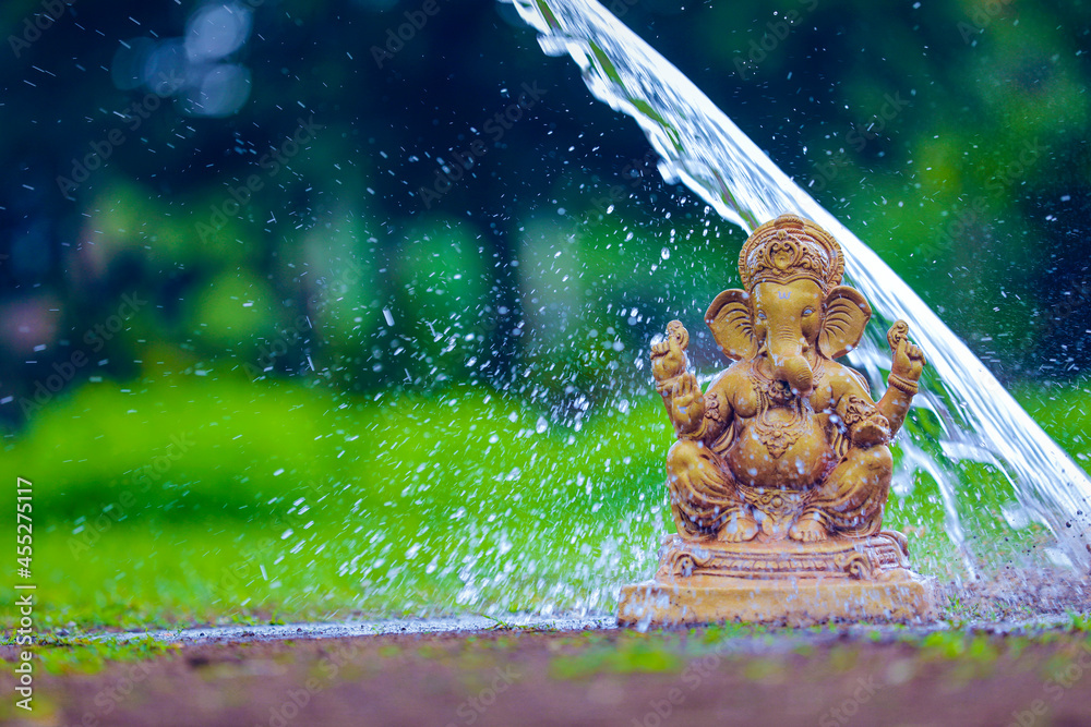 Water splash on lord ganesha sculpture. celebrate lord ganesha festival ...