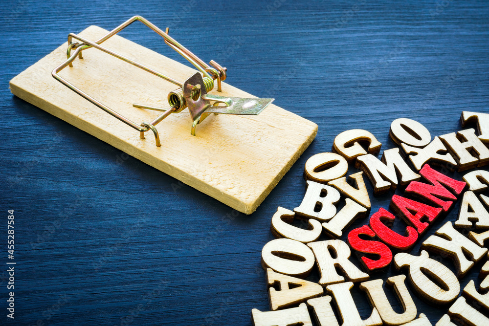 Word scam from red letters and mousetrap. Stock Photo | Adobe Stock