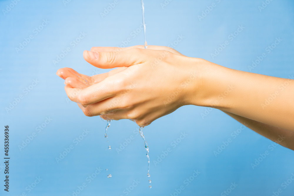 Persona lavándose las manos con agua y jabón. Agua vertiendo entre las ...
