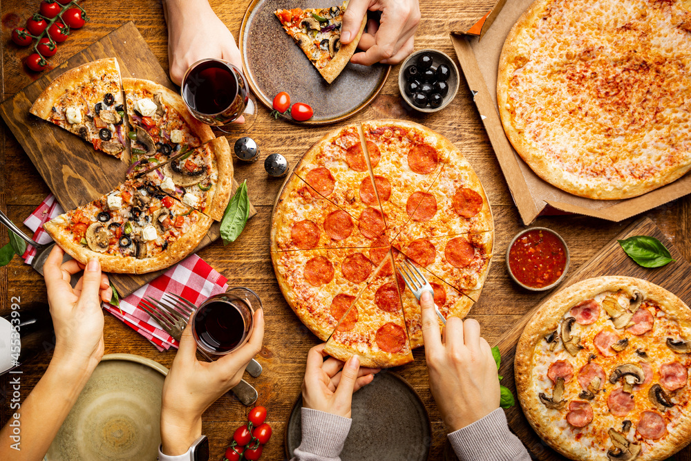 Family or friends pizza party. Flat-lay of people eating different ...