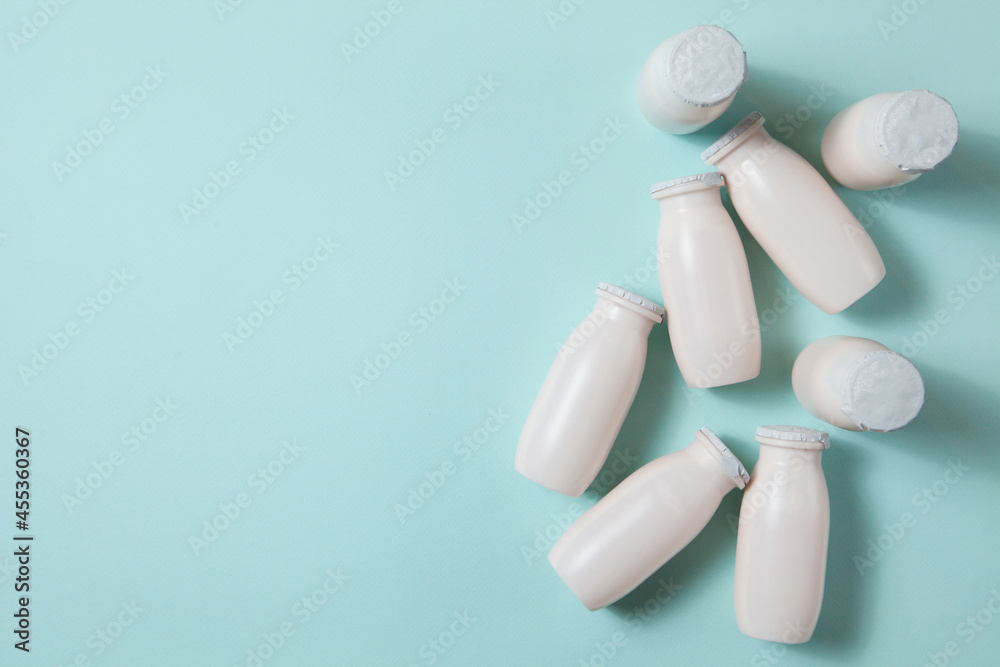 Bottles with probiotics and prebiotics dairy drink on light blue ...
