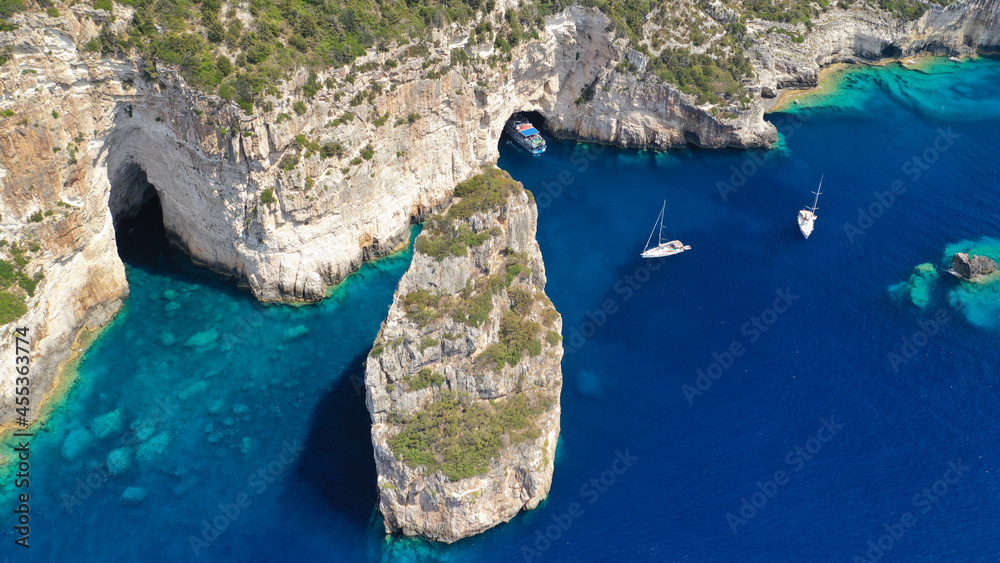 Aerial drone photo of iconic Ortholithos and azure caves with deep ...