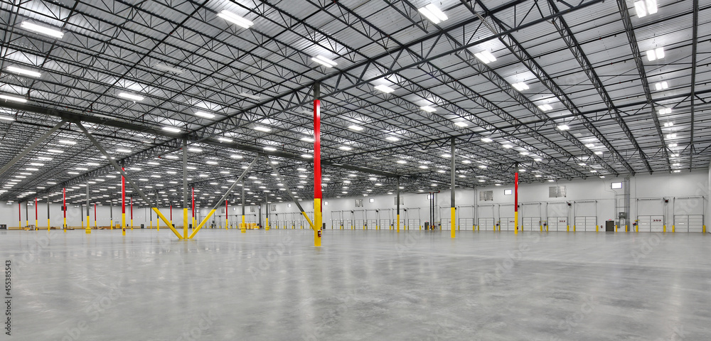 Interior of large well-lit industrial warehouse distribution storage ...