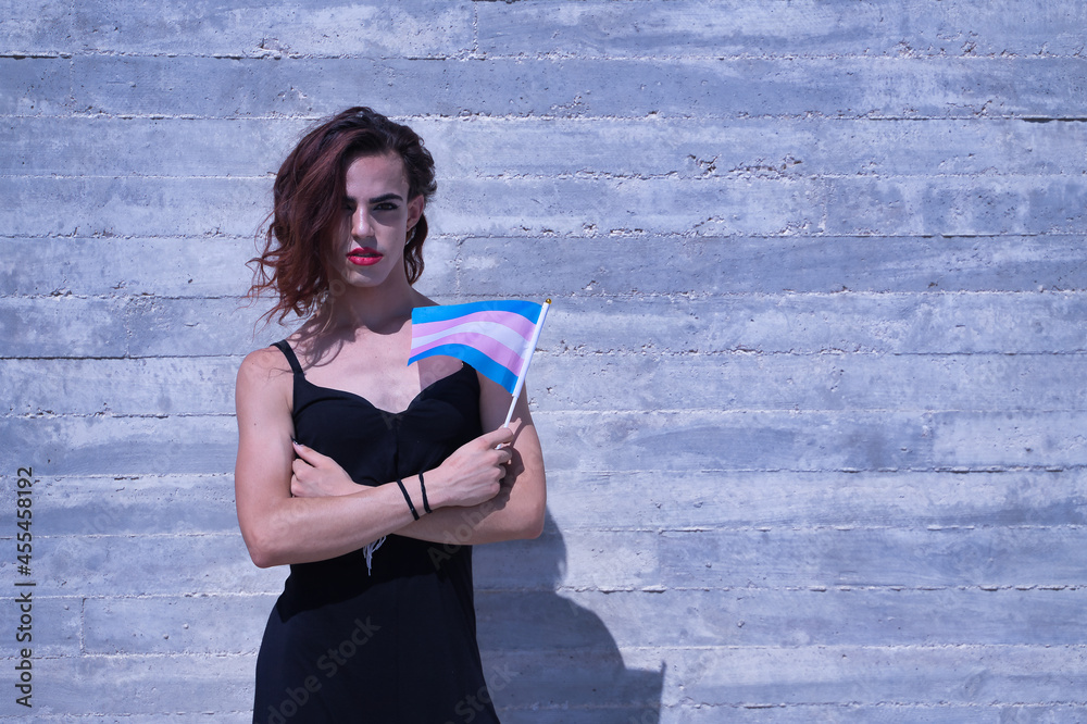 Young Hispanic and transgender adult girl with her arms crossed and a ...