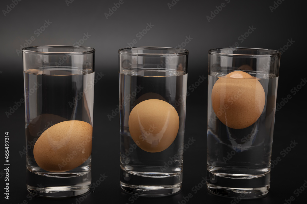 Eggs in water test on transparent glass , Egg freshness test on black ...