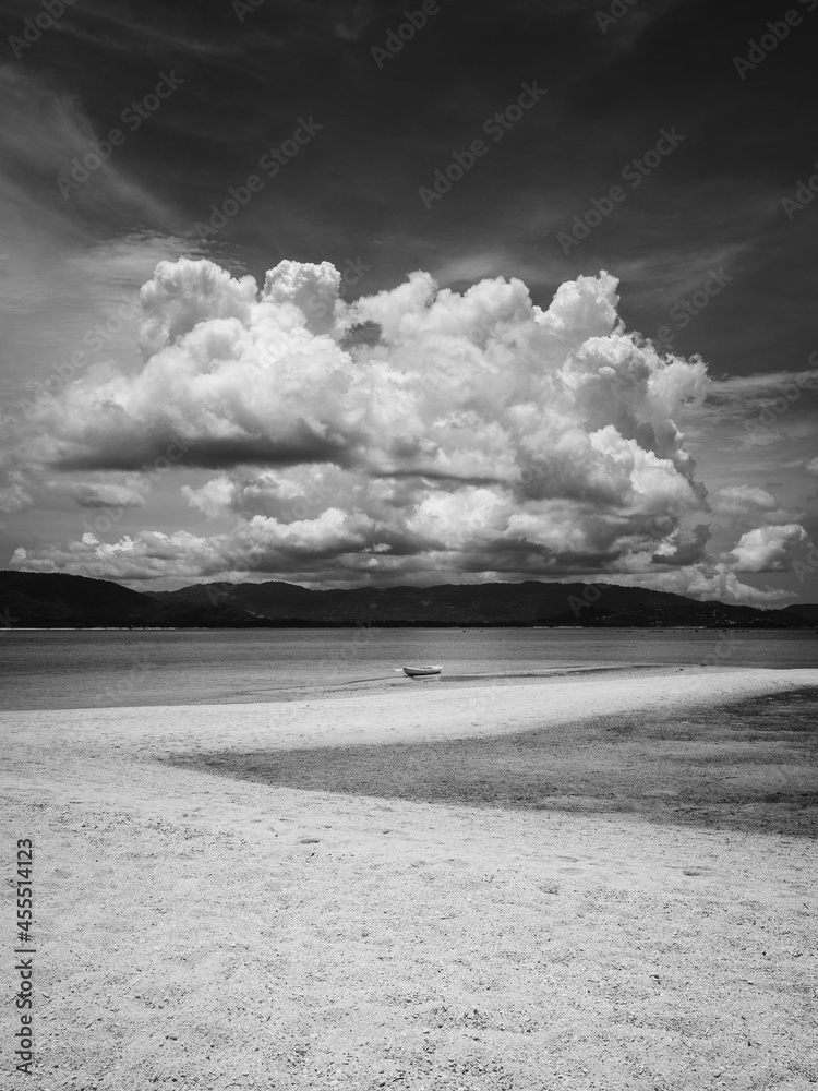 Dramatic sandbank with kayak of tropical island against moody cloudy ...