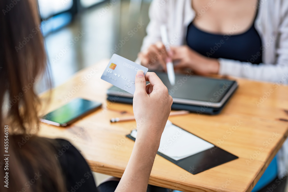Back view of a woman hand holding a credit card idea of payment using ...
