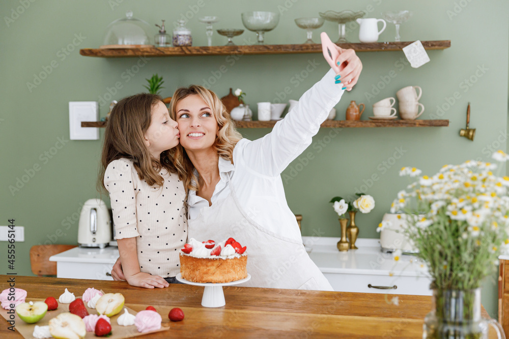 Happy chef cook baker mom woman in white shirt work baby girl helper do ...