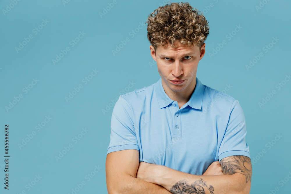 Displeased disappointed frowning young curly man 20s years old wears ...