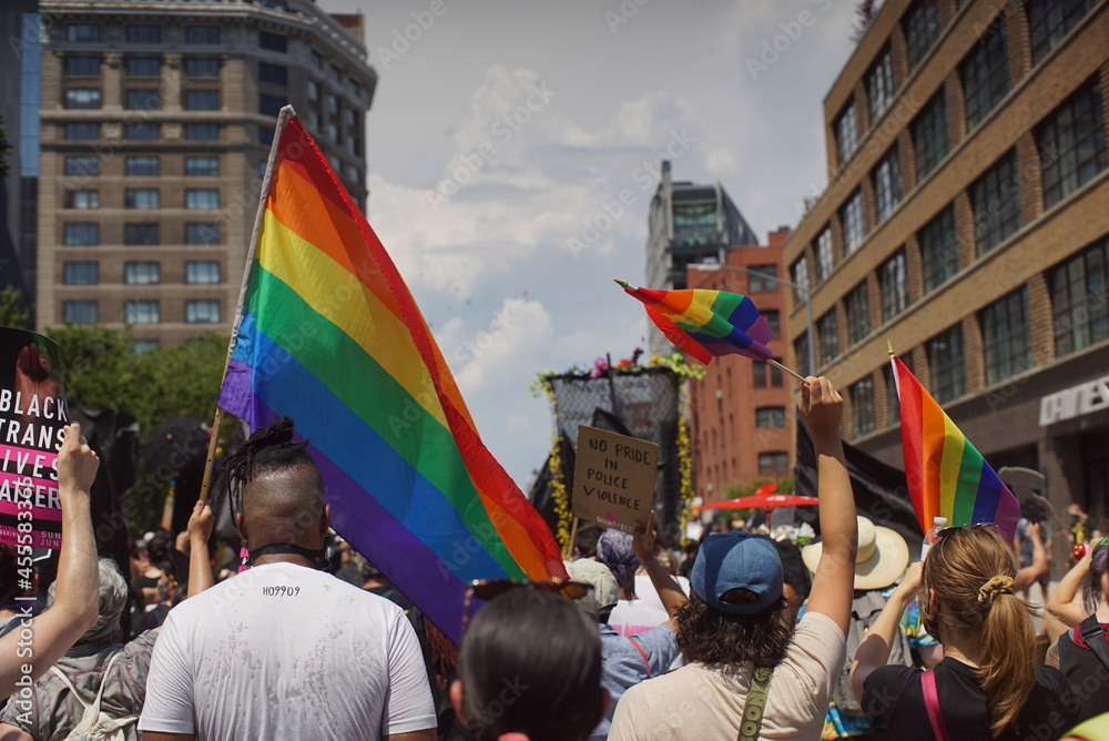 Foto de People raising LGBTQ flags and a banner with " no pride in ...
