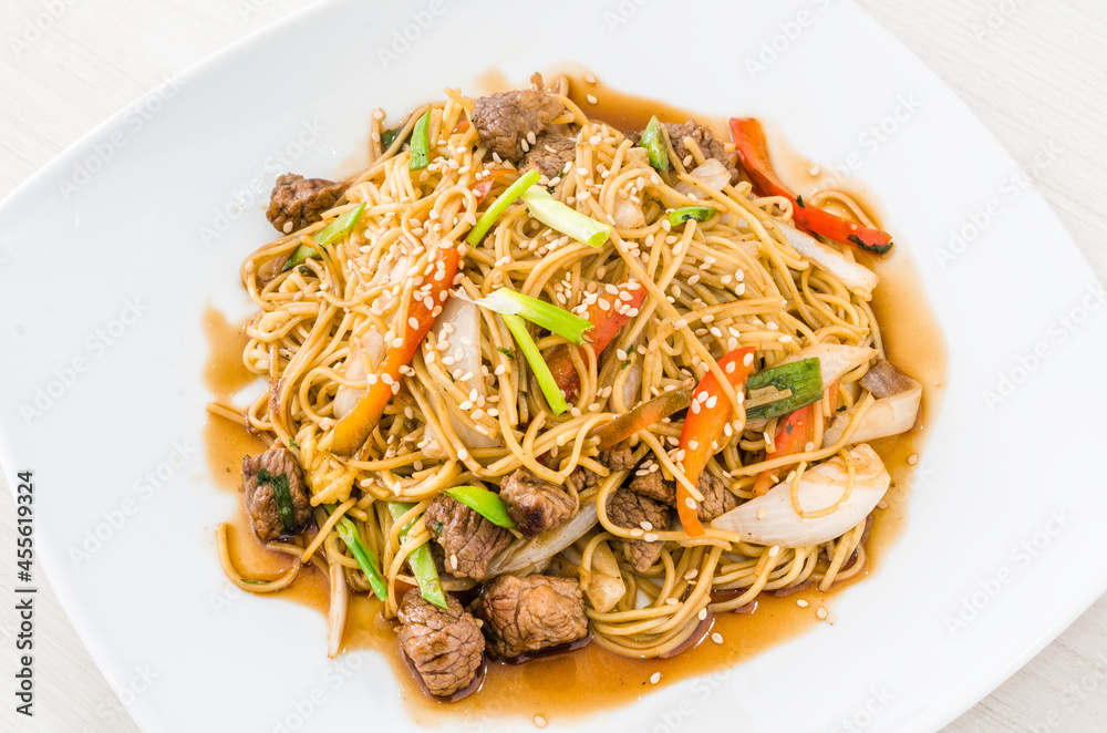 Peruvian style beef spaghetti pasta with basil leaves called tallarin ...