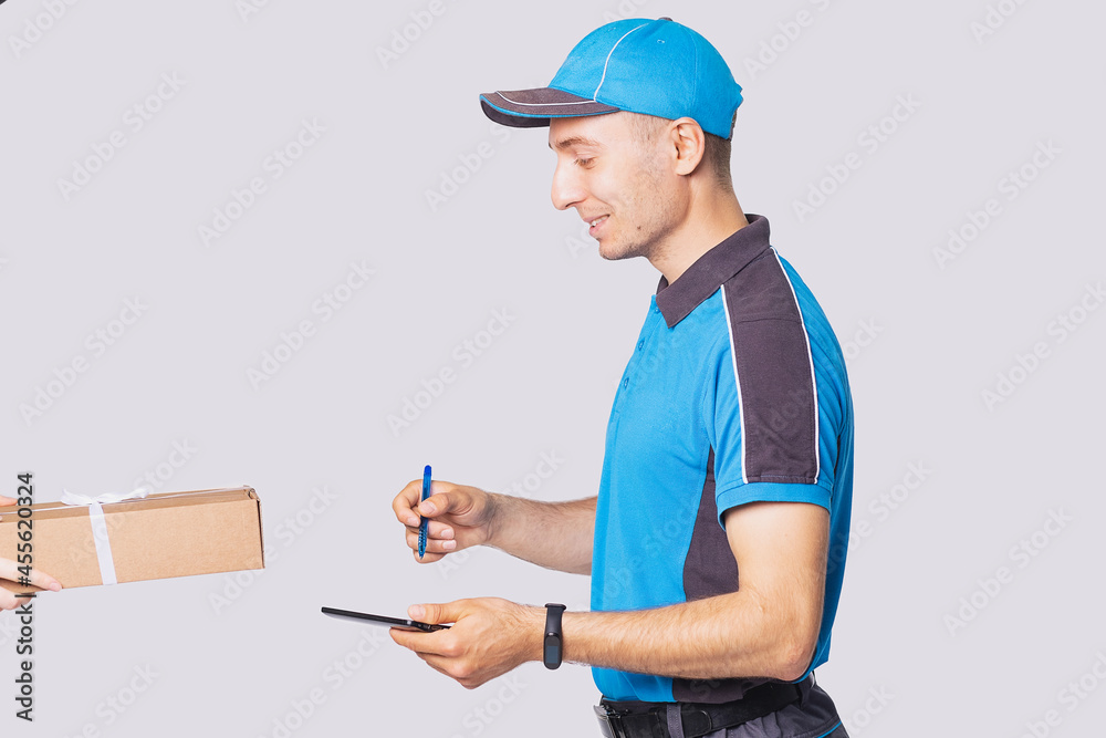 Side view photo of a delivery man in postman uniform wearing digital ...