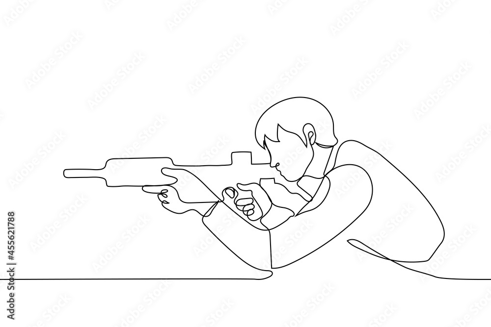 man is aiming with a long-barreled weapon leaning on his elbows - one ...