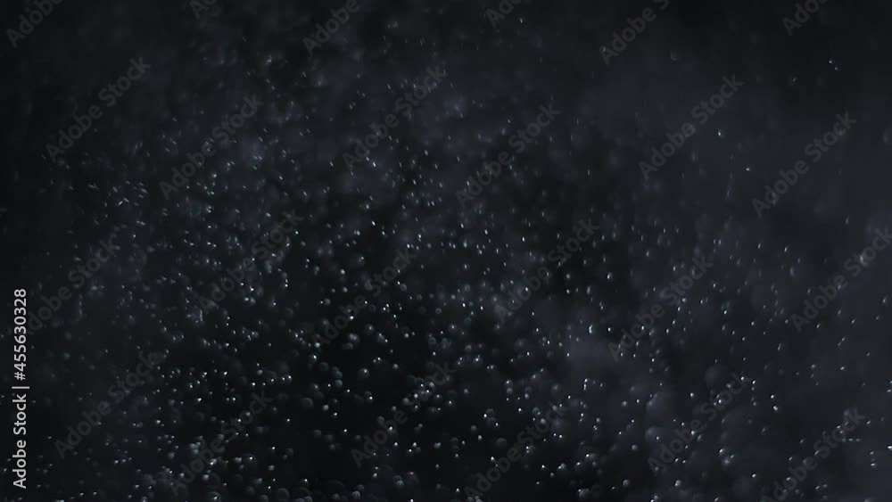 Video Stock A suspension of white-silver particles in the air on a ...