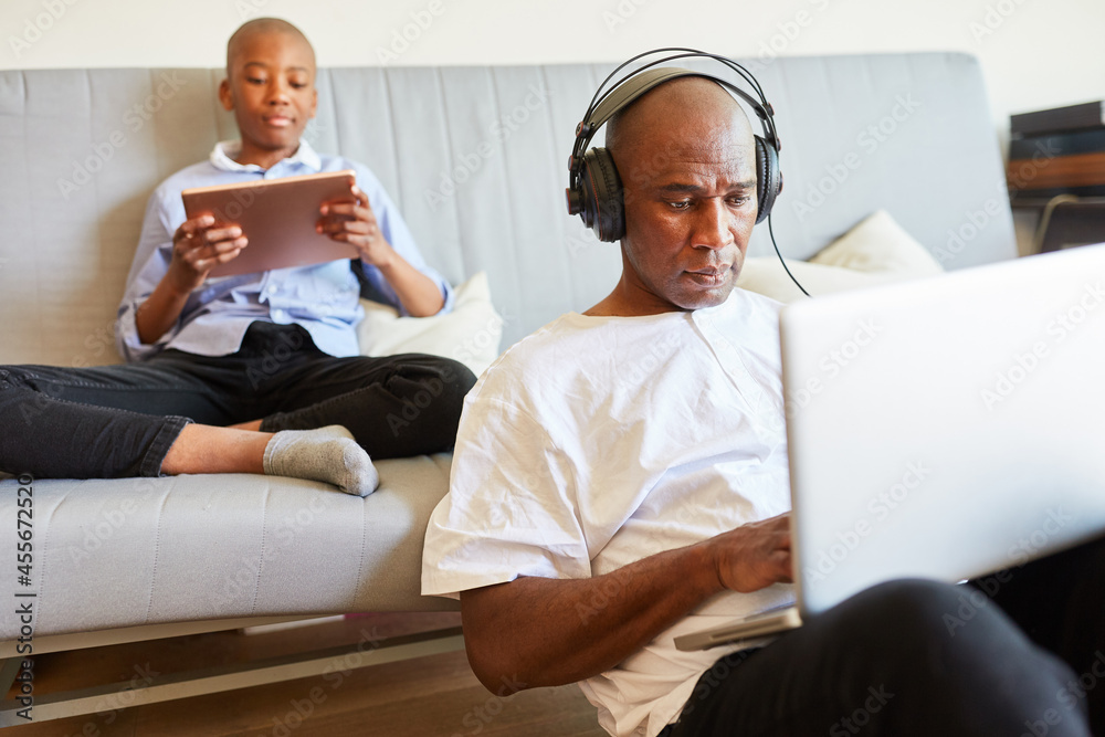 Man in video conference and child in homeschooling Stock Photo | Adobe ...